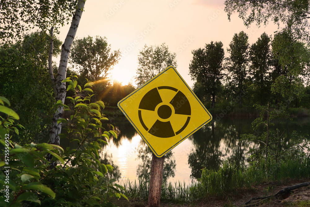 Radioactive pollution. Yellow warning sign with hazard symbol near ...