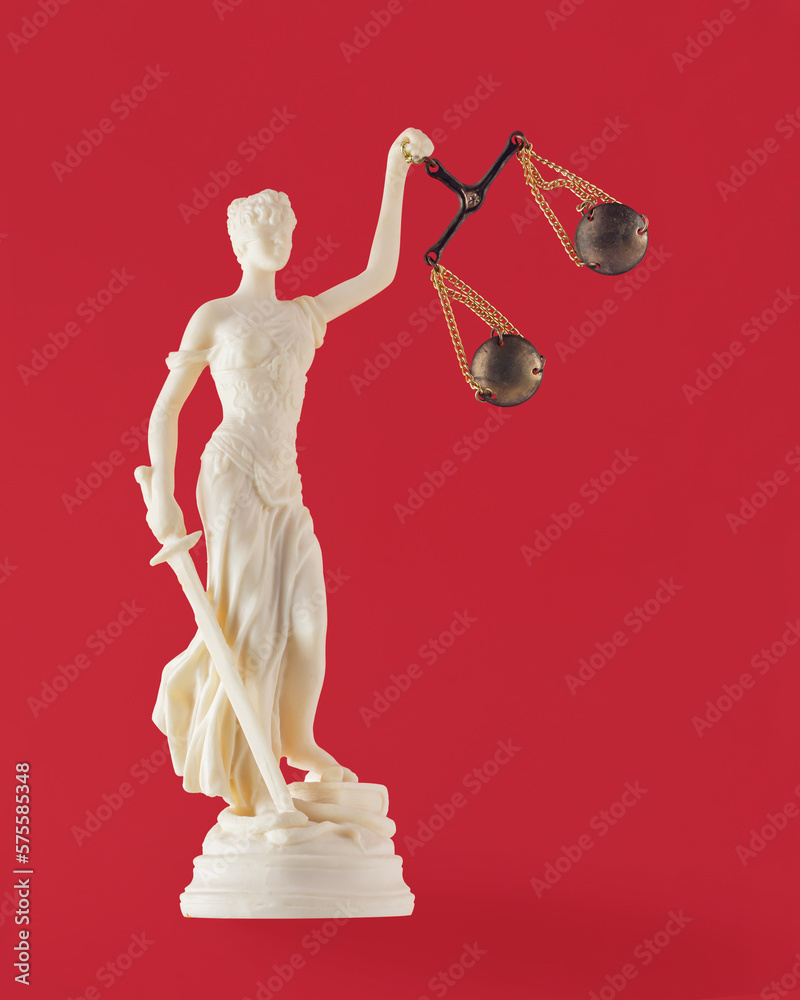 Pastel beige statue of Lady Justice swings her hand holding scales on ...