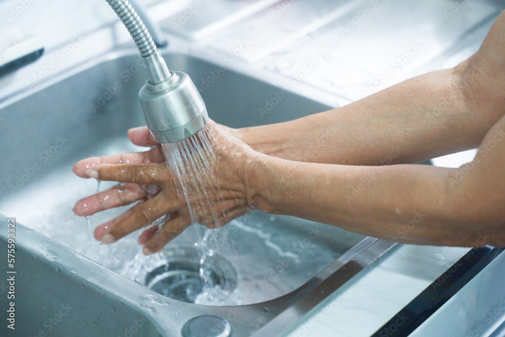 Elderly woman hands washing. Hand hygiene to prevent infection. Take ...