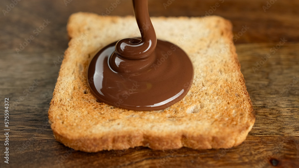 Pouring Сhocolate paste on roasted toast bread. Perfect traditional ...
