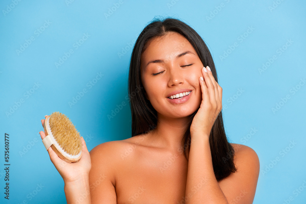 People and body care concept. Happy young Asian woman keeps body brush ...