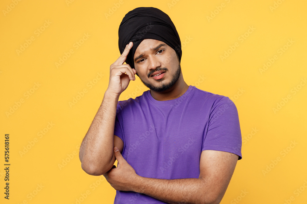 Sad minded devotee Sikh Indian man ties his traditional turban dastar ...