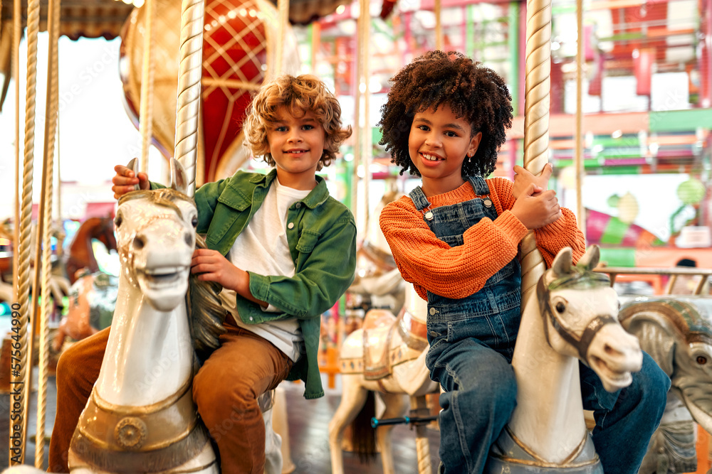 Kids having fun on a carnival Carousel Stock Photo | Adobe Stock