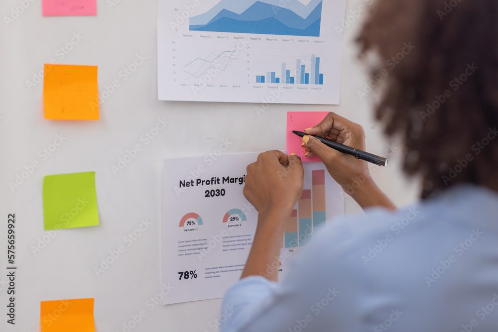 young asian entrepreneur of small company putting a adhesive sticky ...