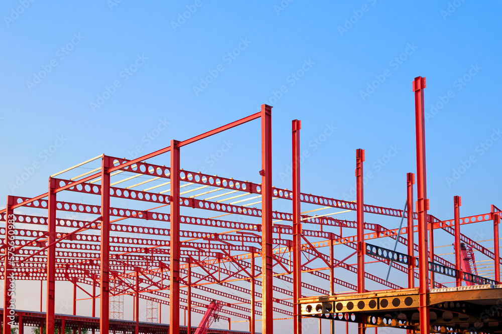 Morning sunlight on surface of Red metal castellated beam structure of ...