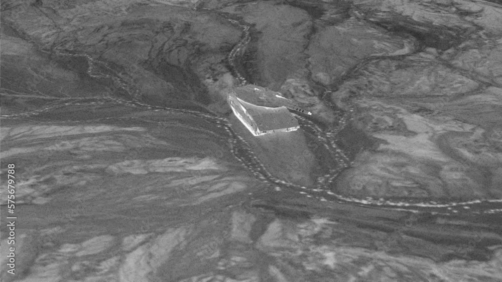 thermal imaging of a military tank doing maneuvers in the desert ...