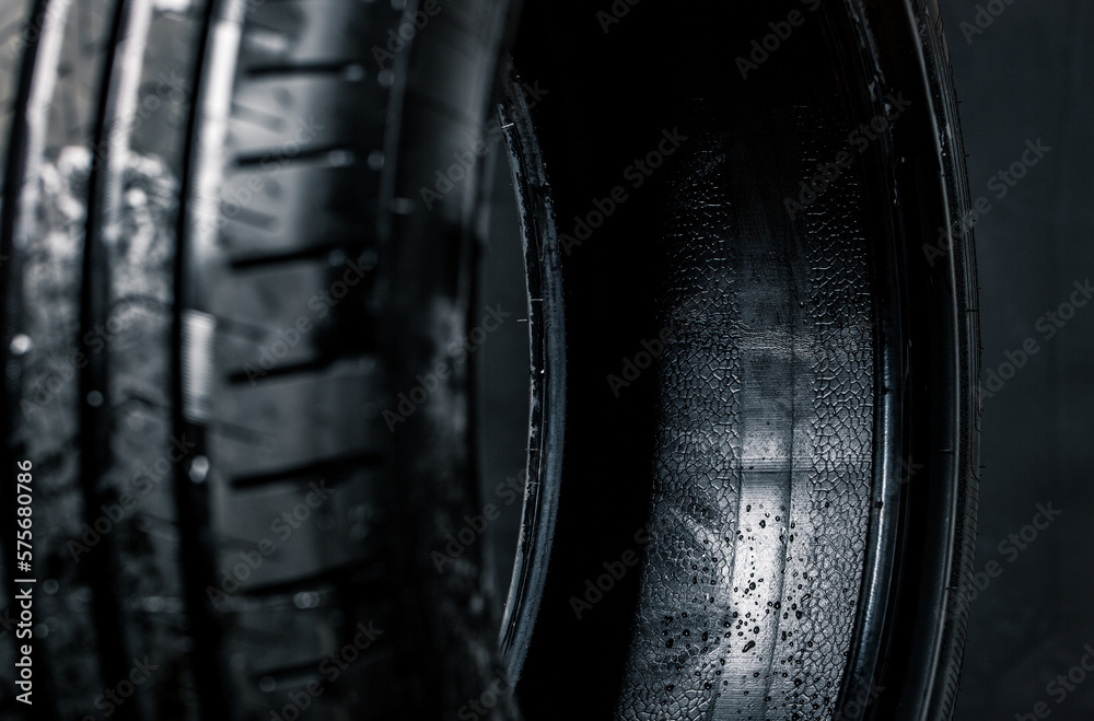 Stack of brand new high performance car tires on clean high-key white ...
