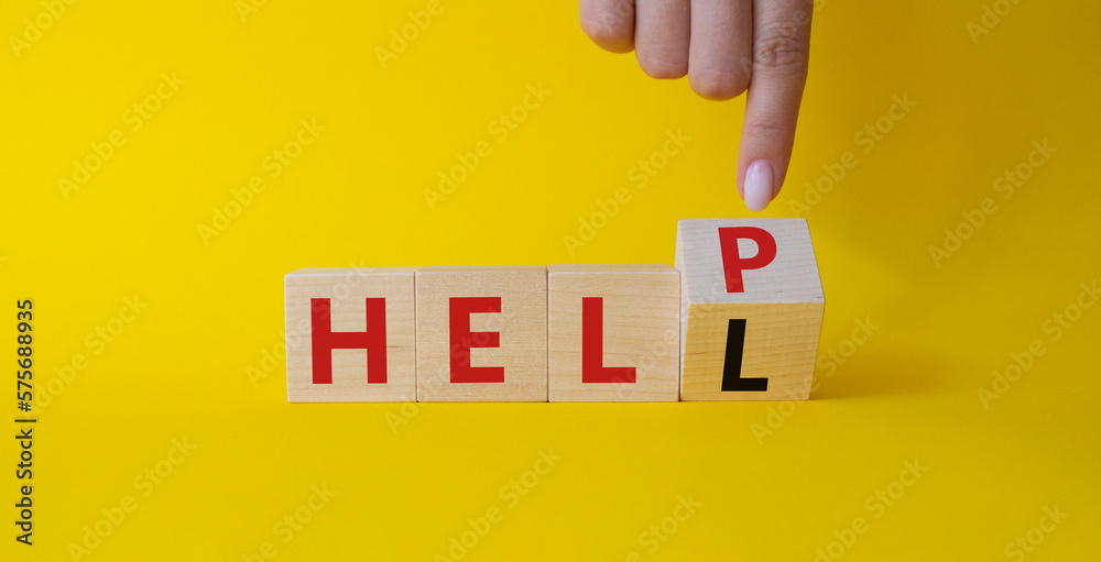 Help vs Hell symbol. Businessman hand points at turned wooden cube with ...