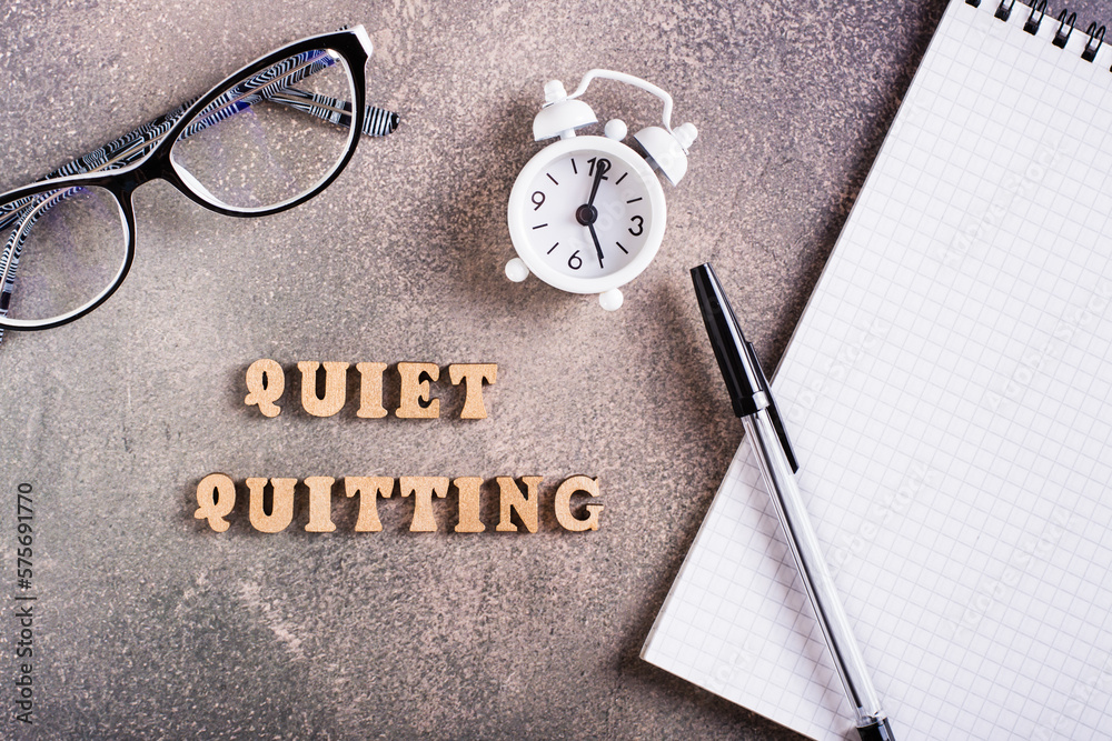 Quiet quitting concept. Wooden letters, stationery and alarm clock. Top ...