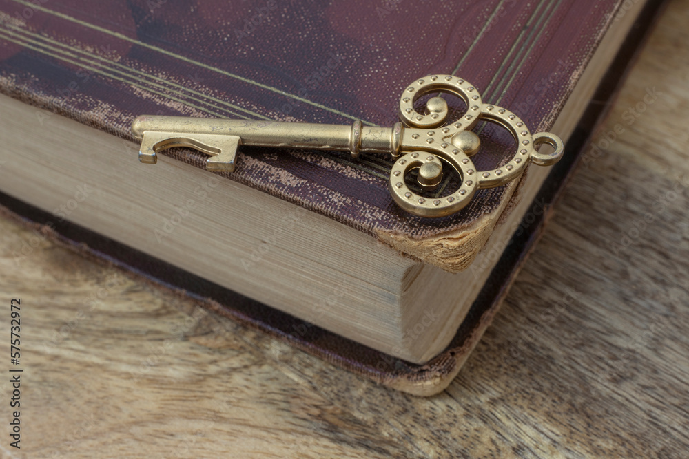Ancient key and old book. Reading books is the key to wisdom and ...