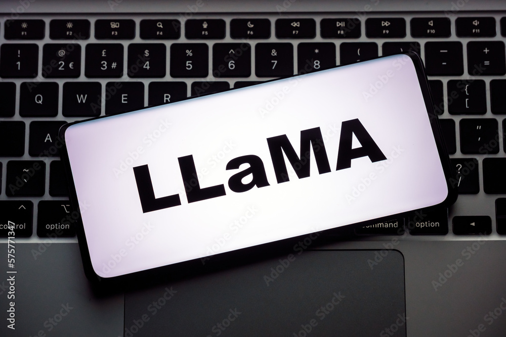 LLaMA letters seen on smartphone and blurred Meta company logo on ...