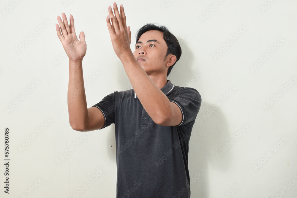 hand gestures swatting mosquitoes. indonesian man in black shirt on ...