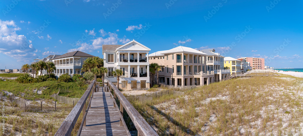 Wooden platform overlooking lavish multi storey beach houses in Destin ...