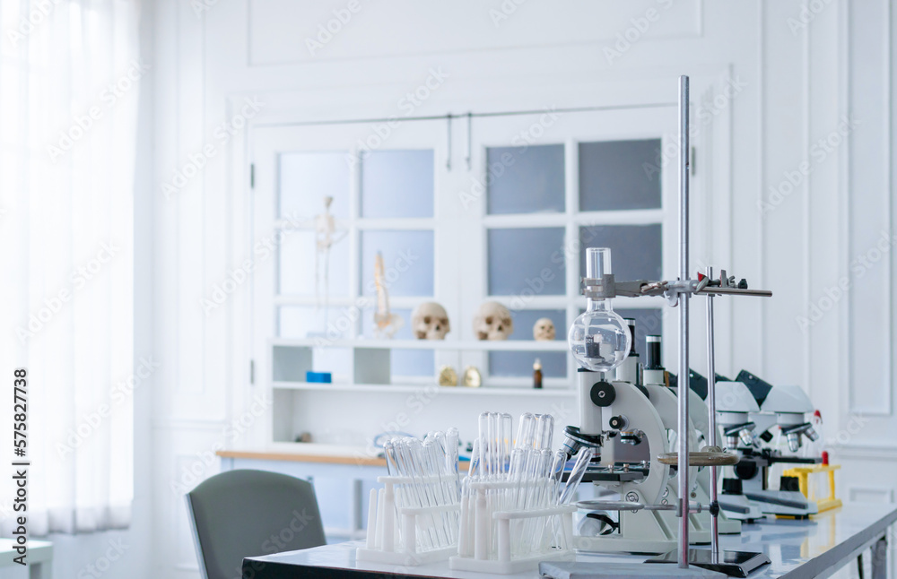 Science laboratory, Microscope and test tubes on the working table ...