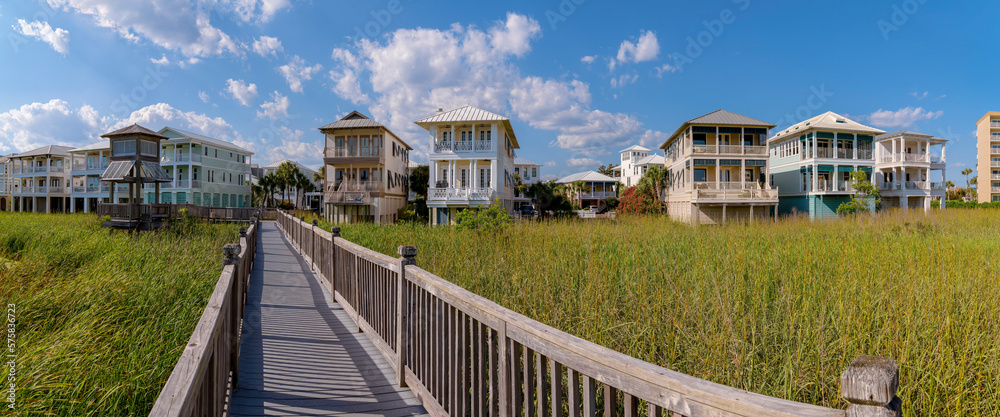 Wooden pathway with railings heading to the homes on the beach at ...