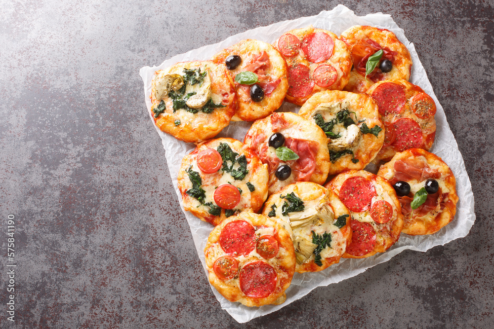 Hot assorted mini pizza or Pizzette with various toppings close-up on ...