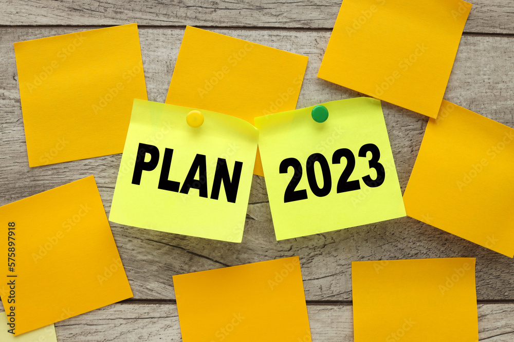 plan 2023 on desk. text on bright pinned stickers. on the board in the ...