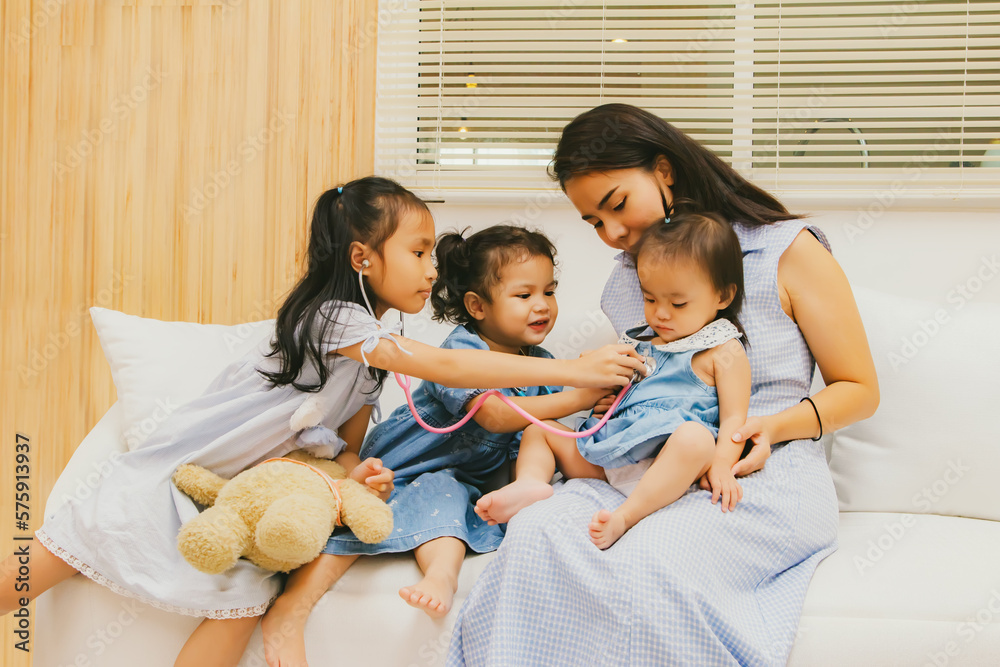 Happy single mother raising three daughters at home : Mother takes care ...