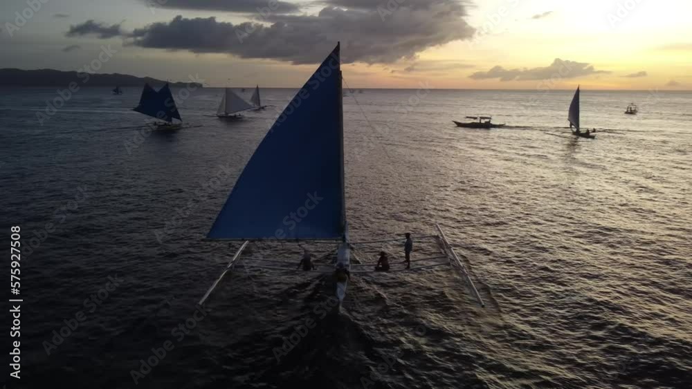Traditional Filipino boats sail El Nido in sunset lights. Palawan ...