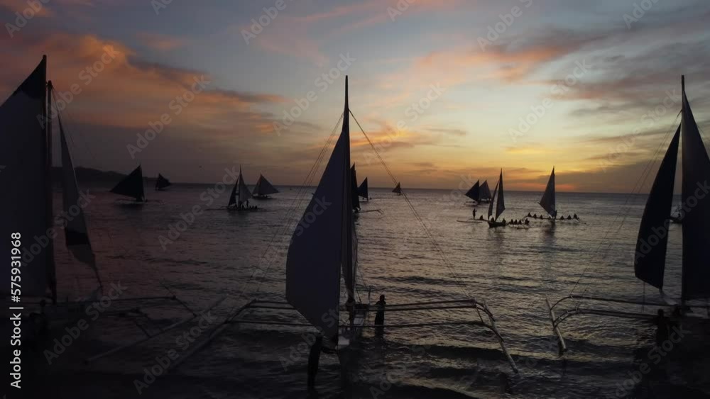Traditional Filipino boats sail El Nido in sunset lights. Palawan ...