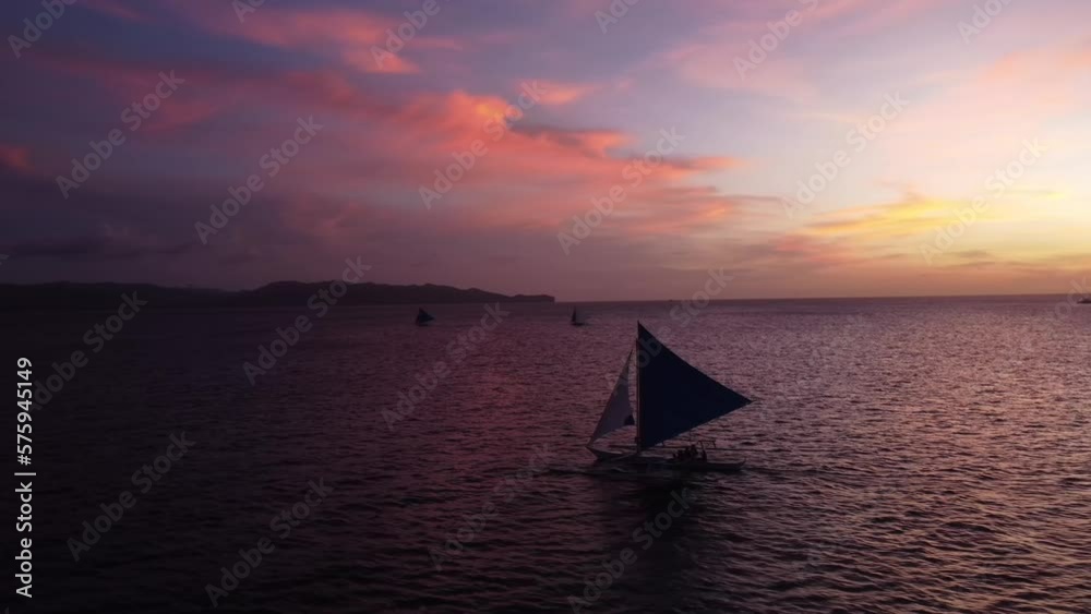 Traditional Filipino boats sail El Nido in sunset lights. Palawan ...