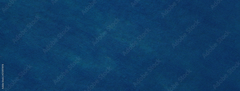 Texture of a navy blue felt background with denim spots of fabric ...