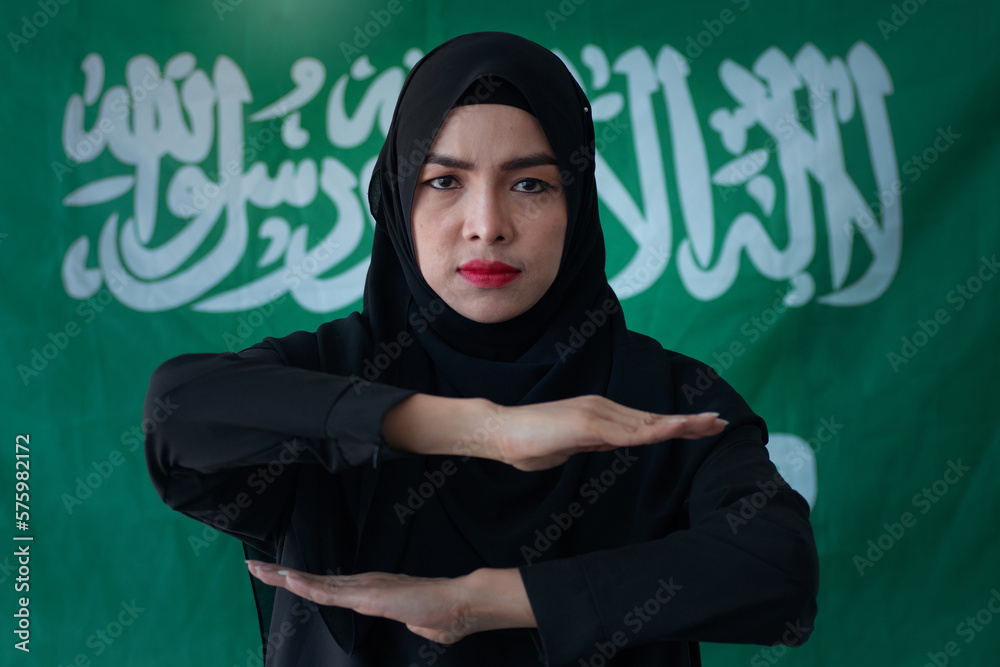 Portrait of Muslim woman wearing black hijab stands in front of the ...