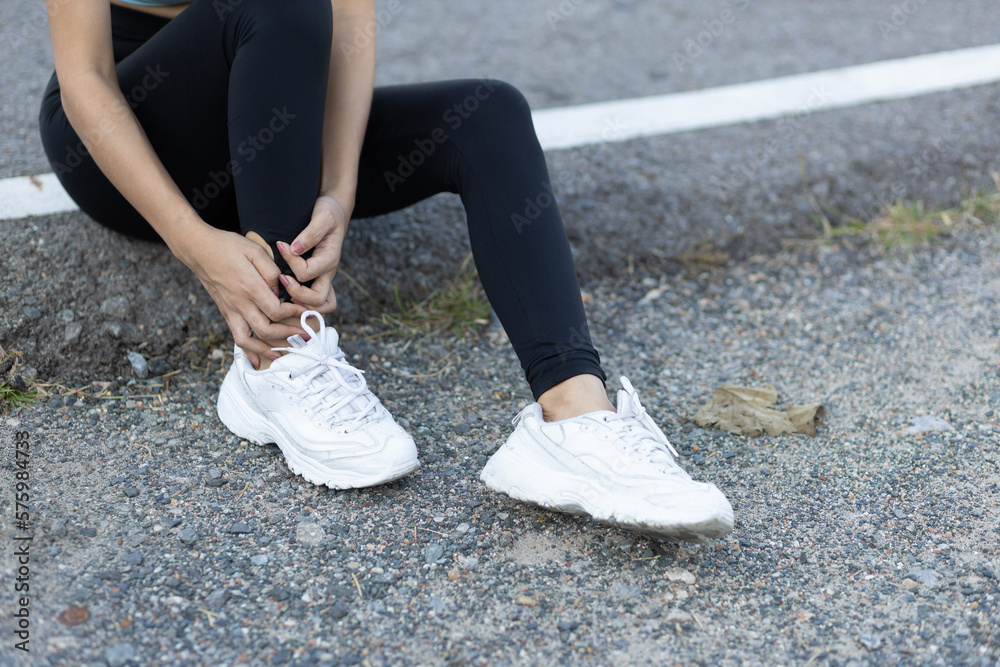 The female athlete suffered an ankle injury. A female runner has pain ...