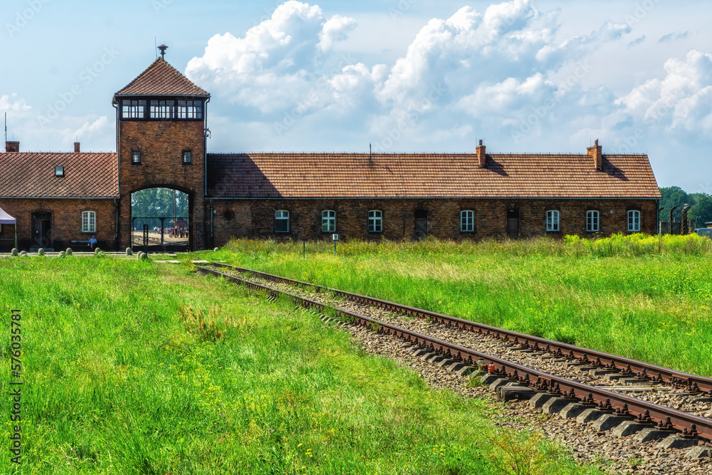 Entrance building and railway line of the former Auschwitz II–Birkenau ...