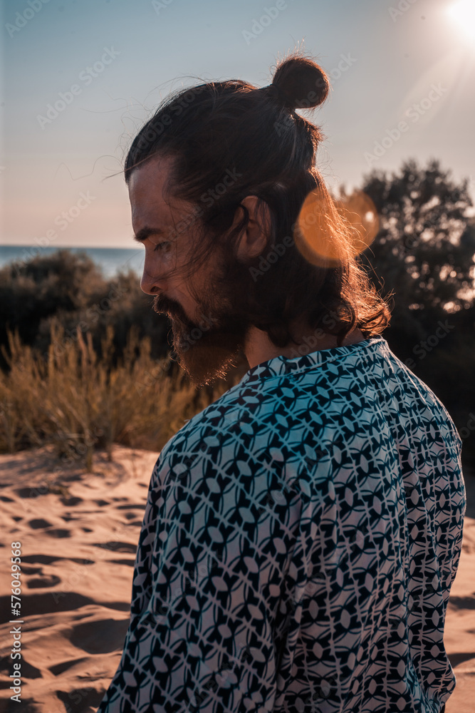 A Japanese warrior in a traditional kimano armed with a katana sword on ...