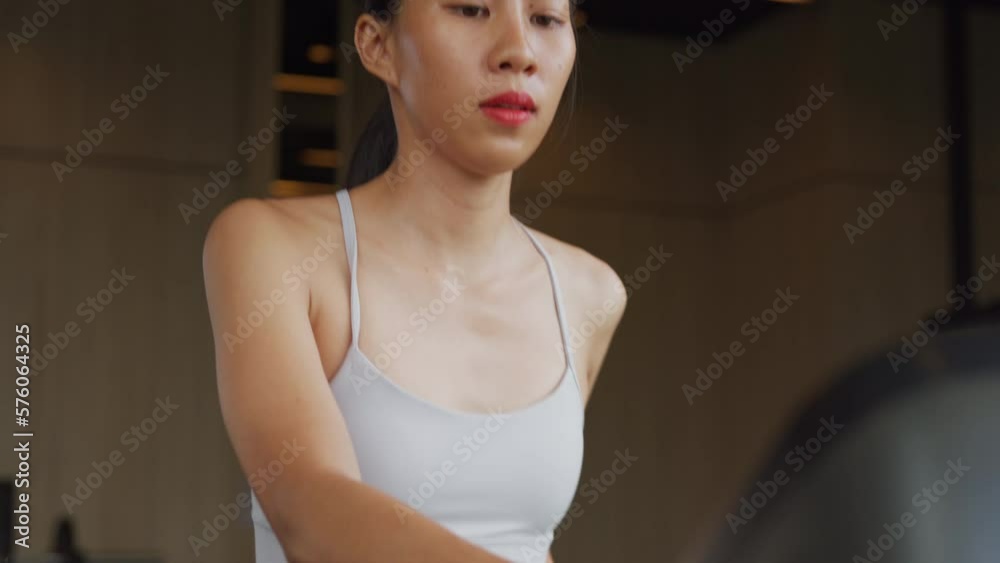 Close-up Side view upper body of attractive young Asian female runner ...