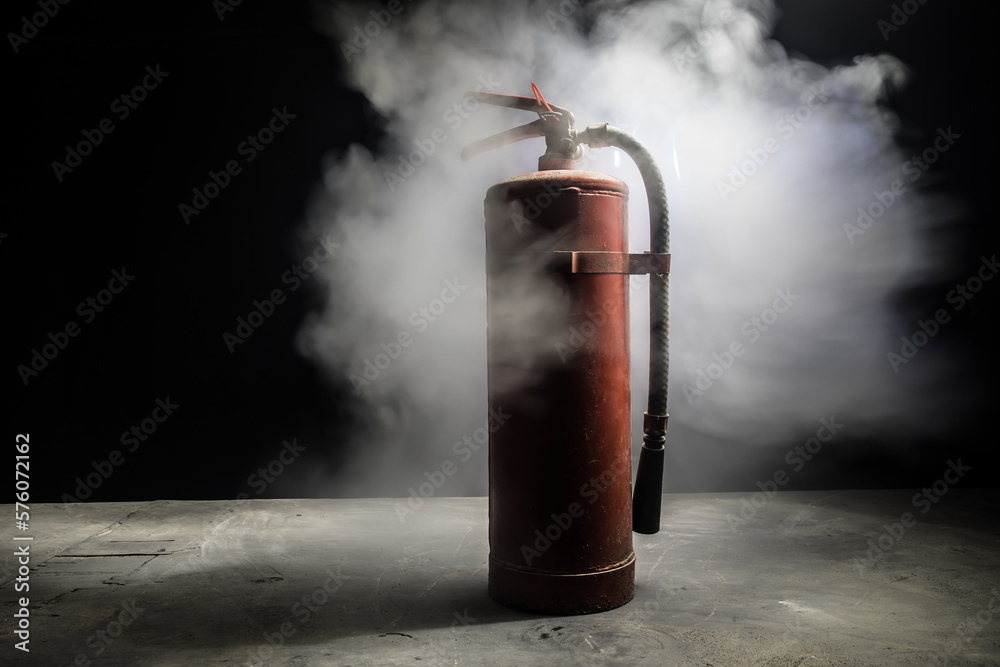 Fire extinguisher on dark background. Fire protection concept. Stock ...