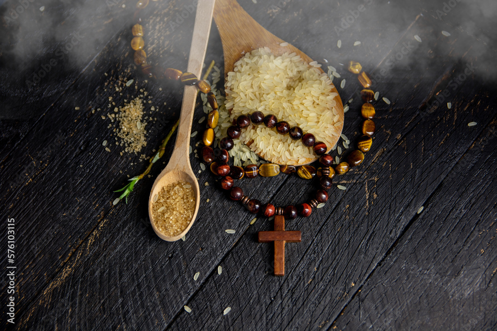 crucifix rosary and rice, Christian cross necklace on dark background ...