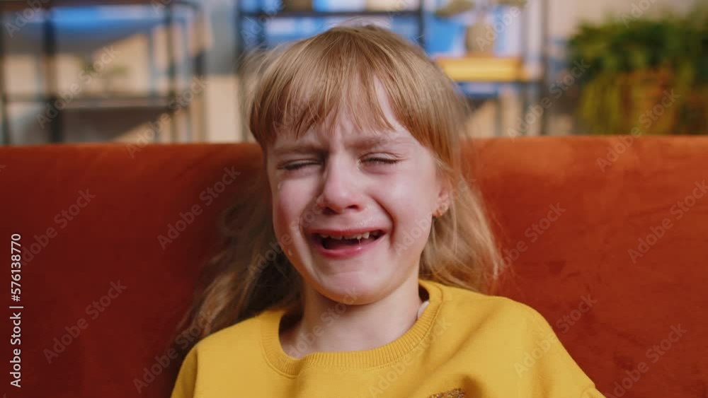 Close-up portrait of upset punished child little girl kid crying with ...