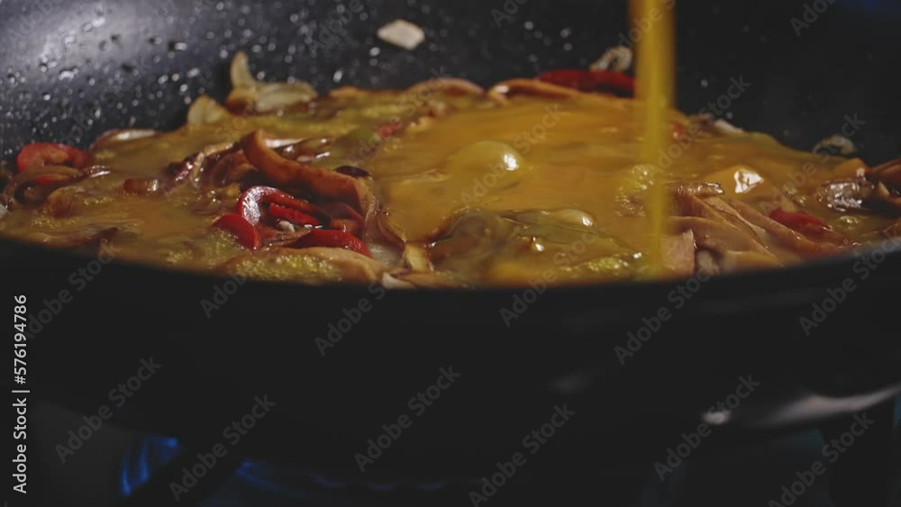A bubbling, popping and steamy closeup of, vegetables in a skillet ...