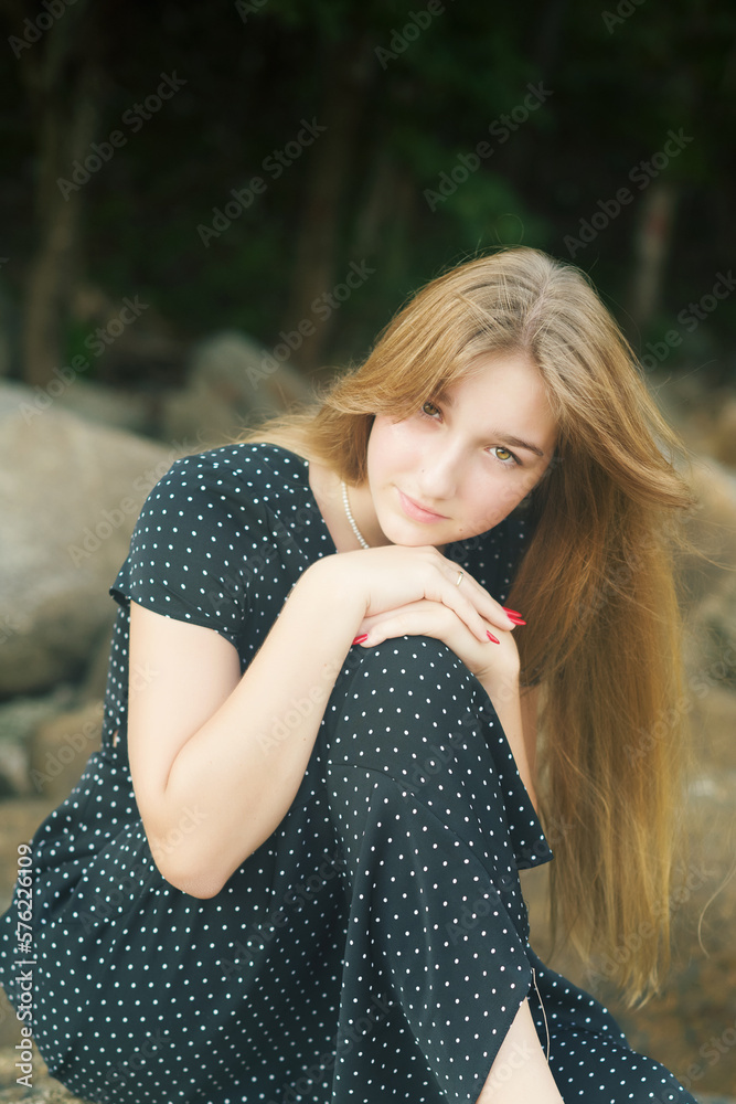 Beautiful young model girl posing at the tropical beach in long black ...