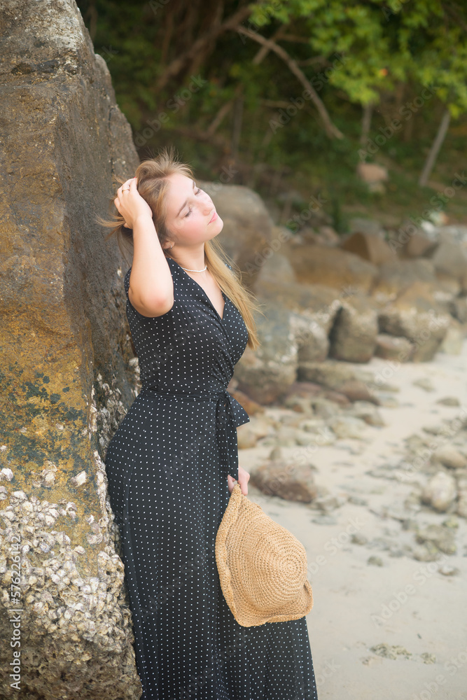 Beautiful young model girl posing at the tropical beach in long black ...