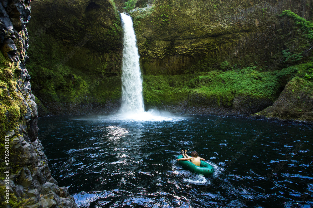 Columbia River Gorge, Oregon, USA. A man floats in a one-person pack ...