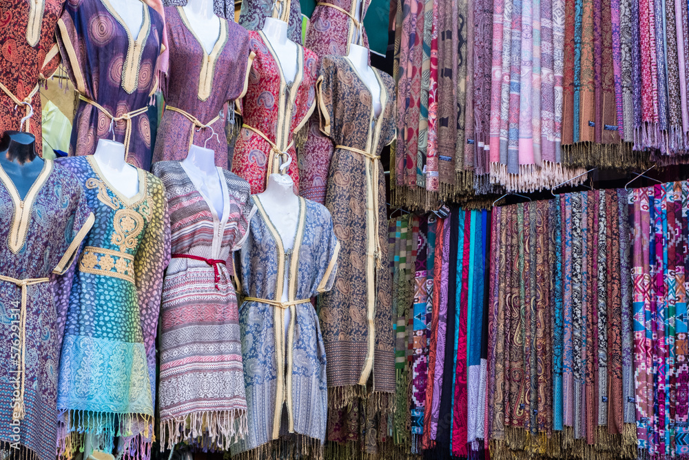typical moroccan clothes on display in a shop in a souk in marrakech ...