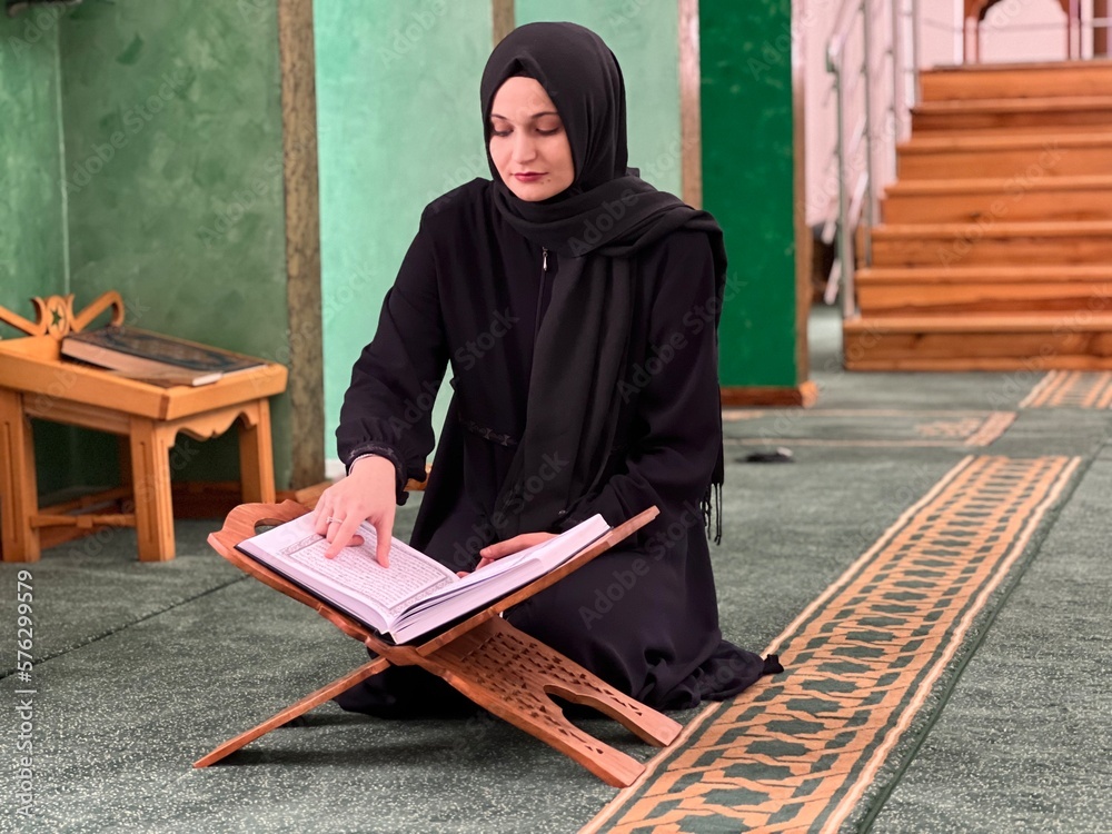 Foto de Muslim girl praying and read the Quran in a mosque do Stock ...