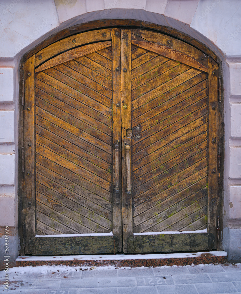 Antique wooden door. Wooden gate with a vaulted top. Architecture of ...