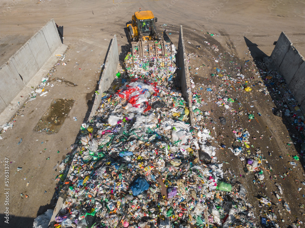 Skid steer loader moving plastic garbage with scrap grapple on the ...