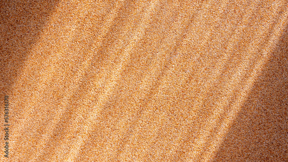 Light and shadow on rough texture surface of orange exposed aggregate ...
