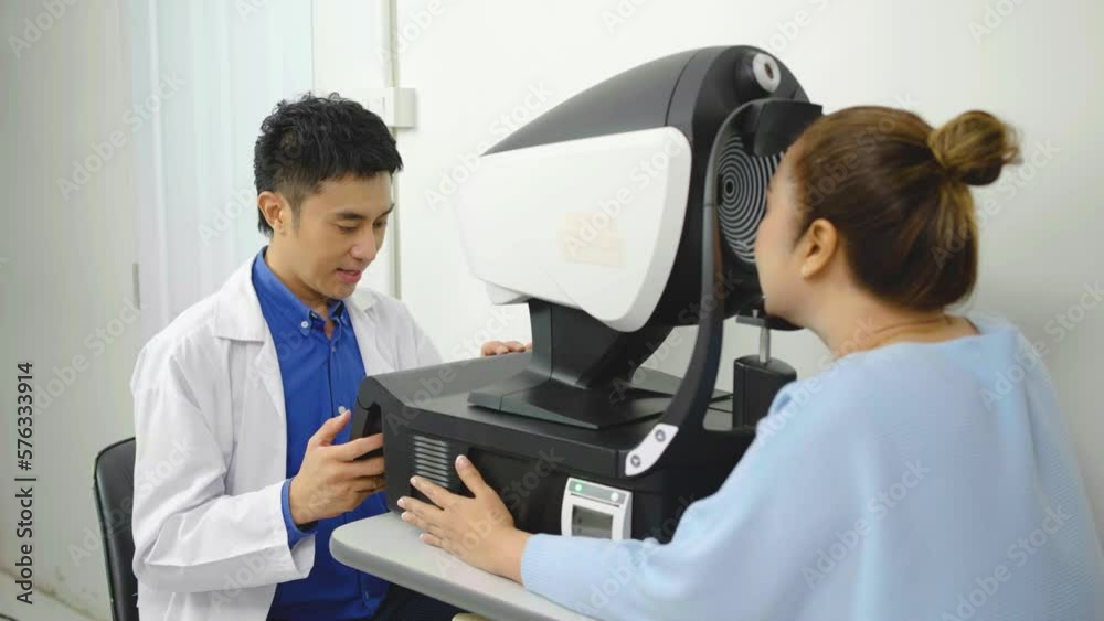 Stockvideon Asian optician doctor working with eye vision measurement machine, Eye exam for ...