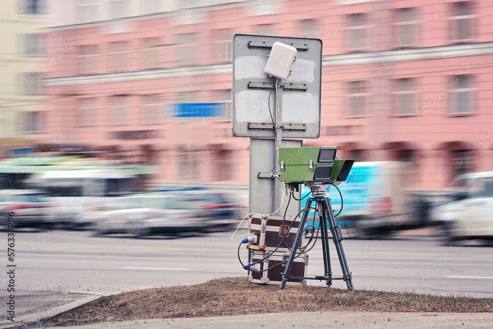 Speed control camera stands on tripod at roadside, mobile police radar ...