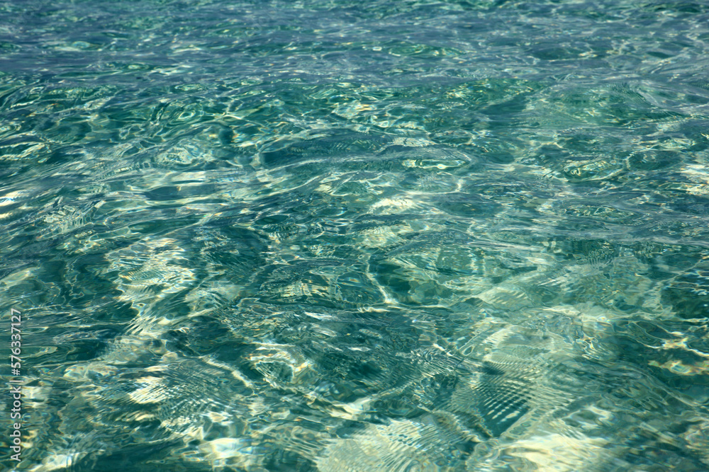 Emerald water texture, transparent sea surface with waves and sandy ...