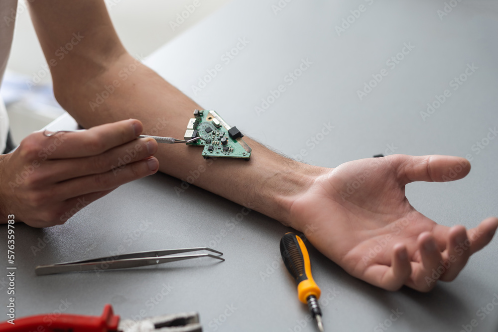 Robot arm concept. Man shows biomechanical prosthetic hand. Guy repairs ...