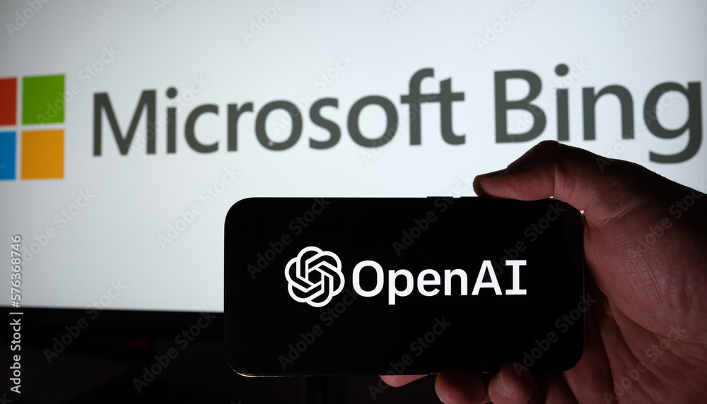 OPENAI Logo Seen On Smartphone Hold in A Hand And Pc Display With MICROSOFT Bing logo On The ...
