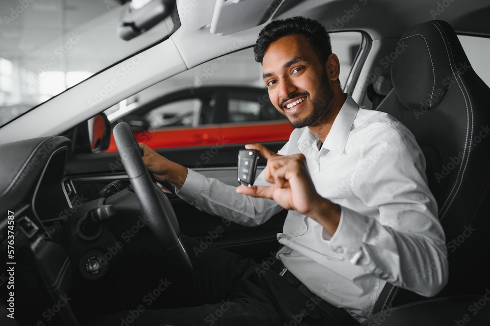 Happy indian man showing the key of his new car Stock Photo | Adobe Stock