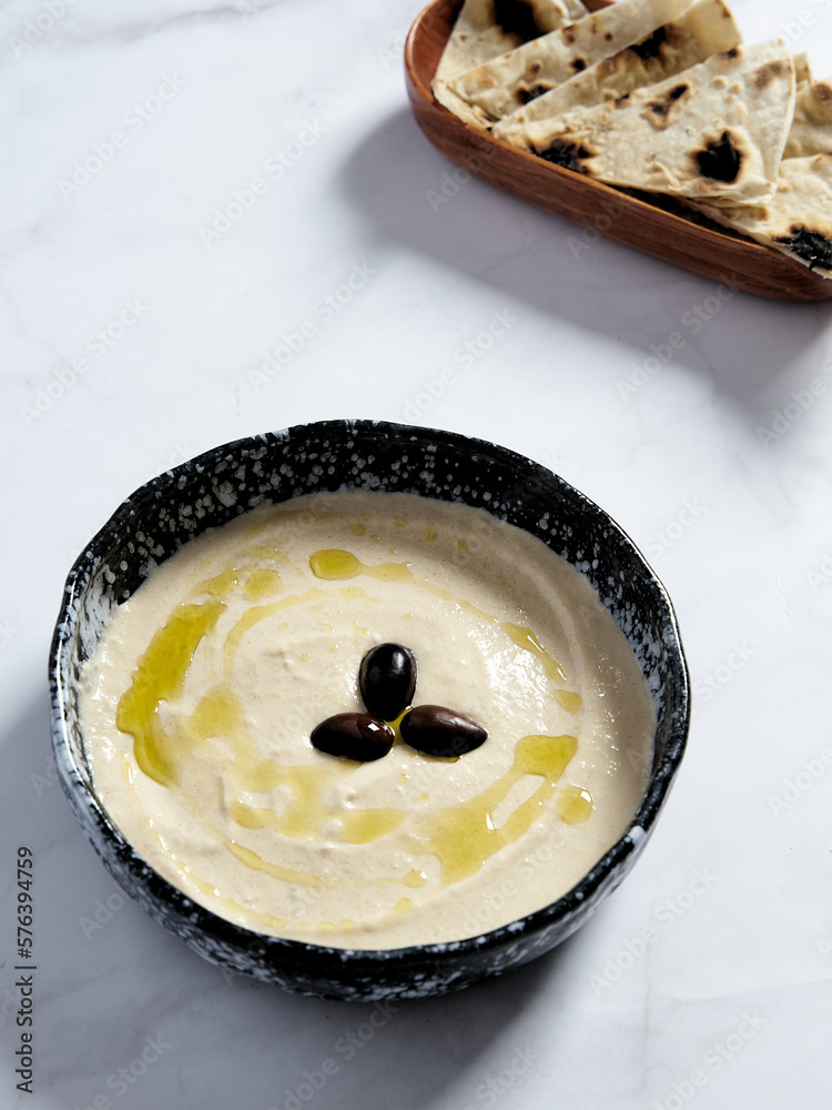 Taramasalata in the bowl with olive oil and black olive. Taramasalata ...